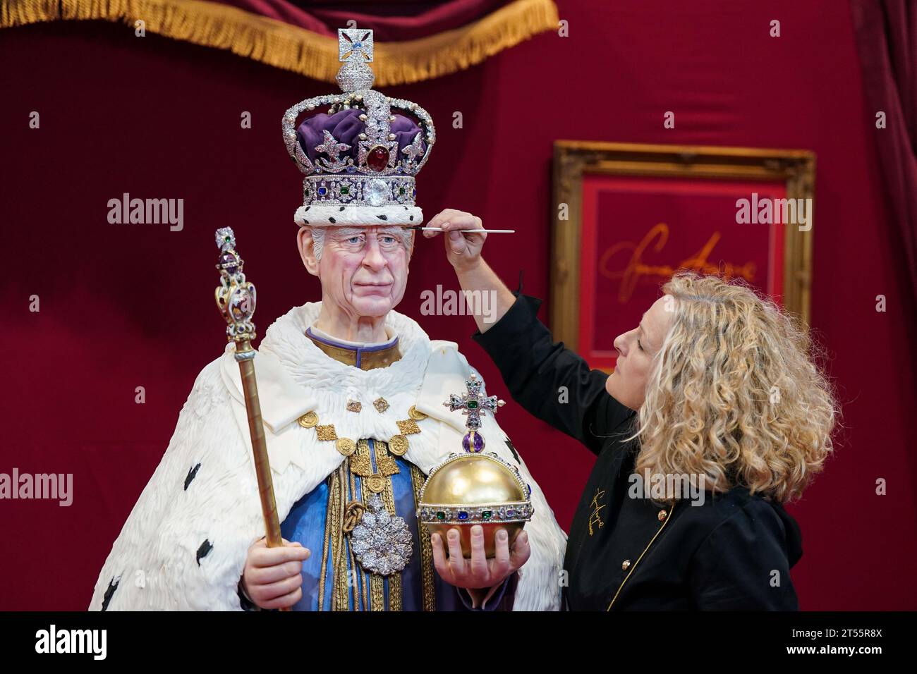 The finishing touches are applied to a lifesize cake figure of King ...