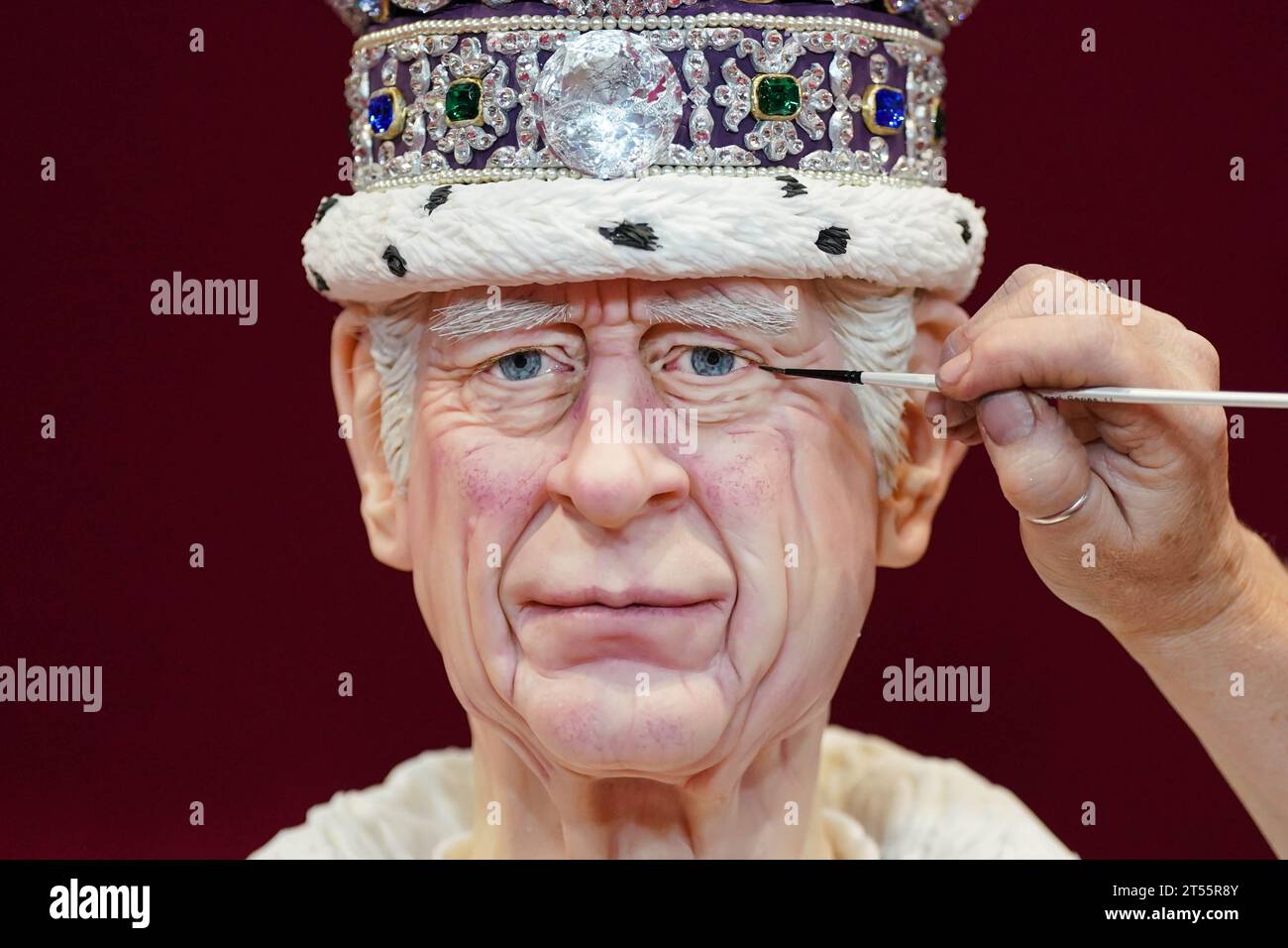 The finishing touches are applied to a lifesize cake figure of King ...