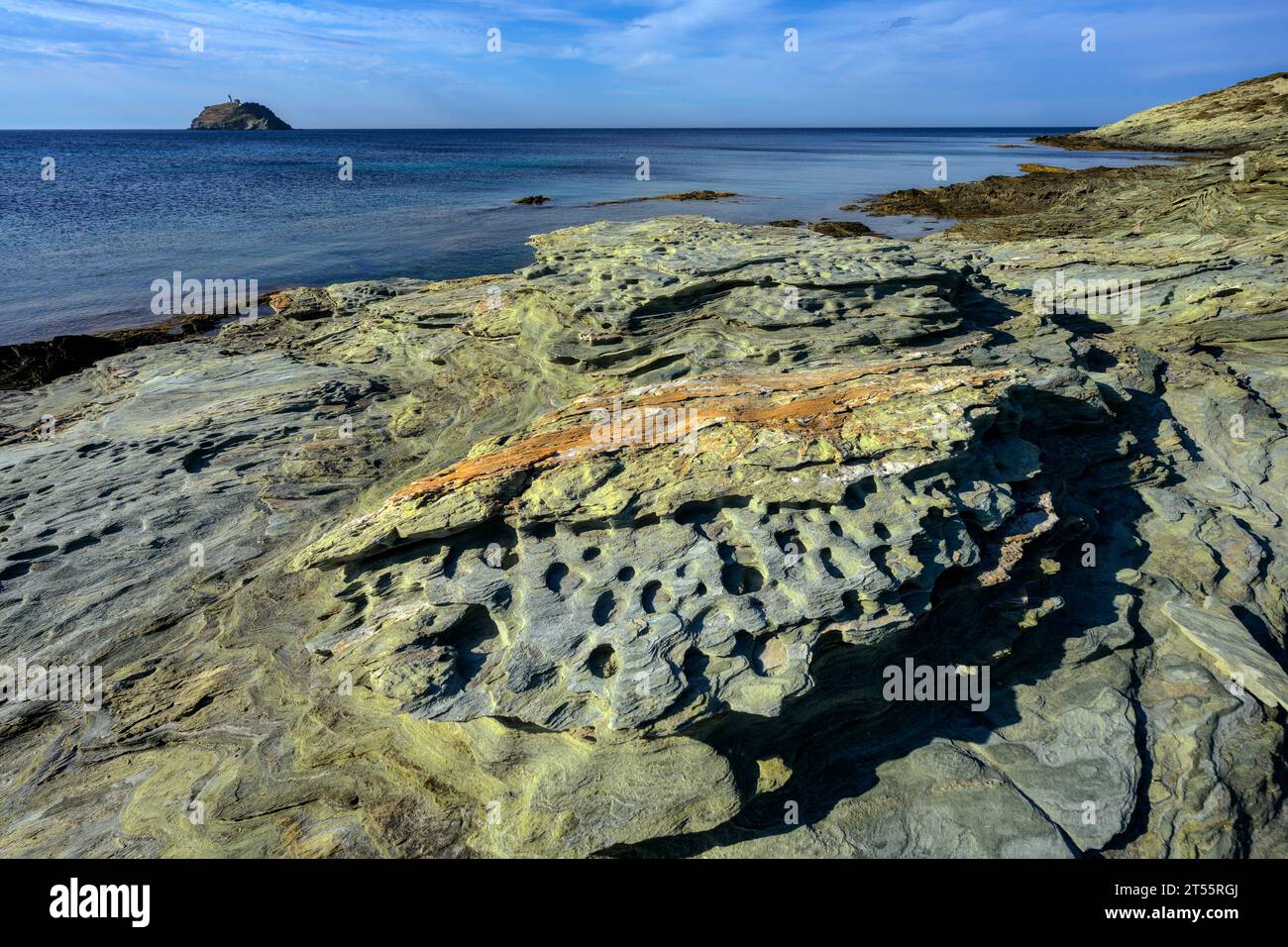 Taffonized prasinites at Cap Corse. Offshore, the island of Giraglia ...