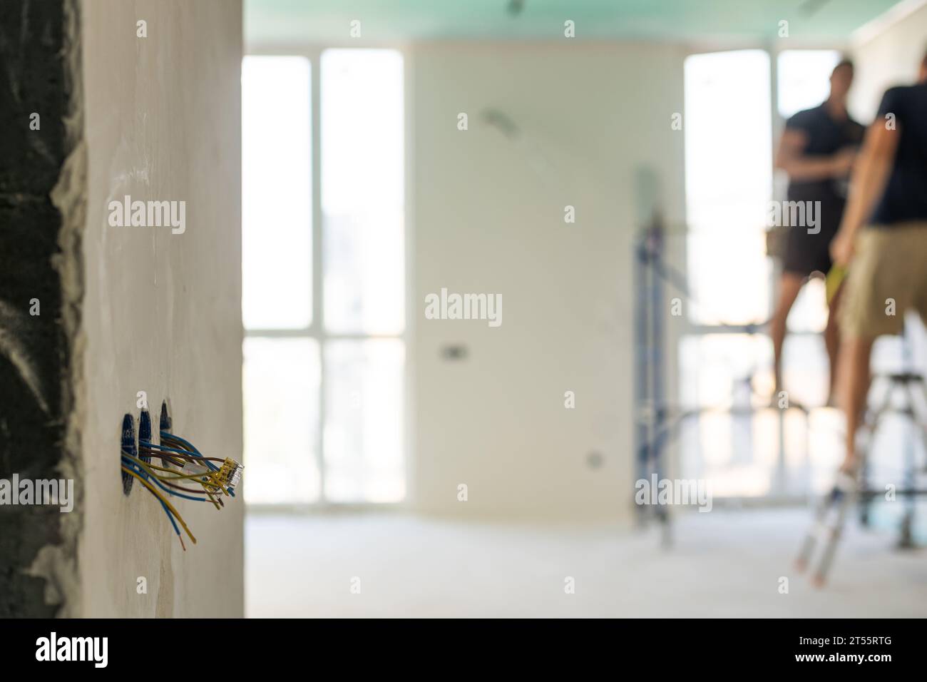 Workers fitting panel into frame of ceiling Stock Photo - Alamy