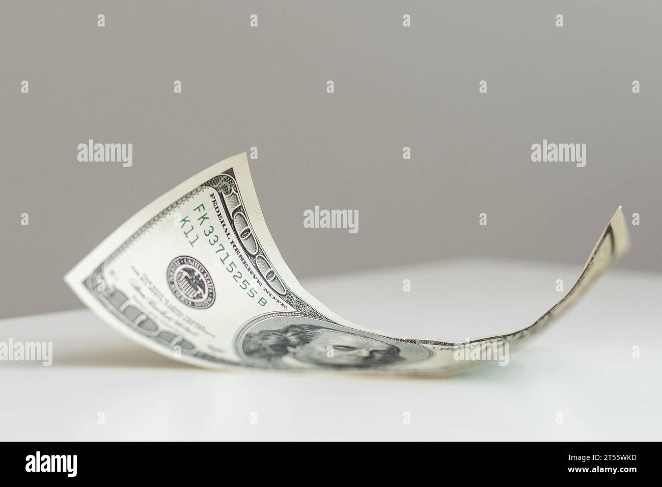 dollar bill curved wave isolated on white background Stock Photo - Alamy