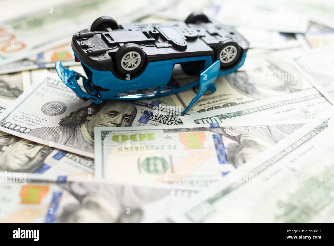 Blue suv toy car accident in overturned composition on money cash on ...
