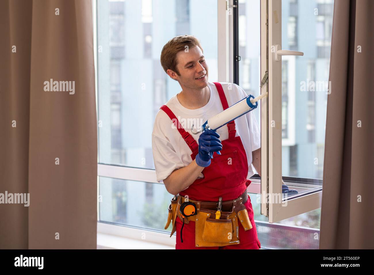 Construction worker installing window in house Stock Photo - Alamy