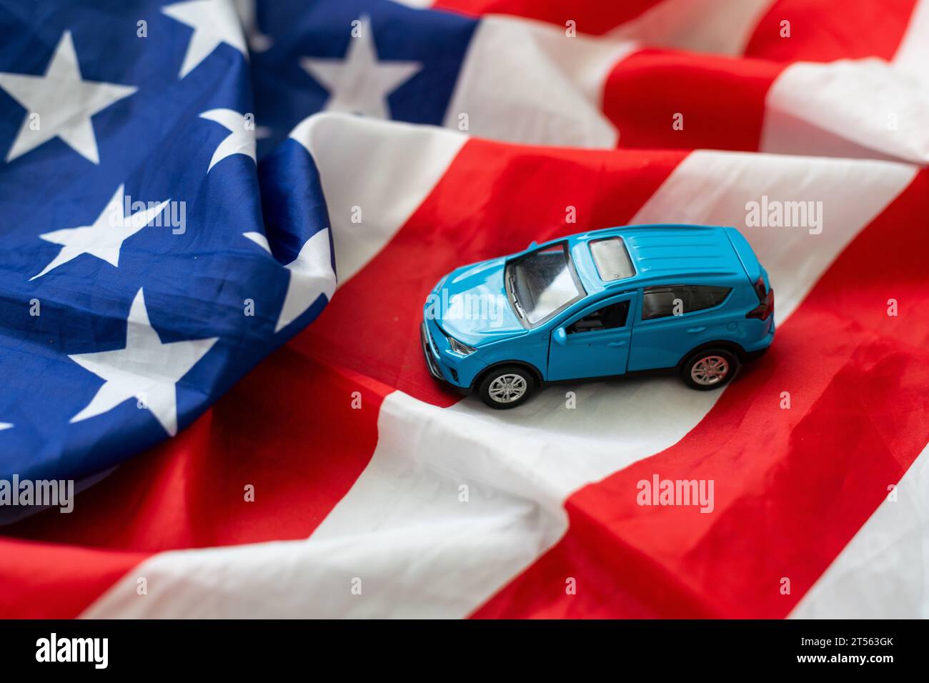 Reflection of American flag in the headlight of a classic car on route ...