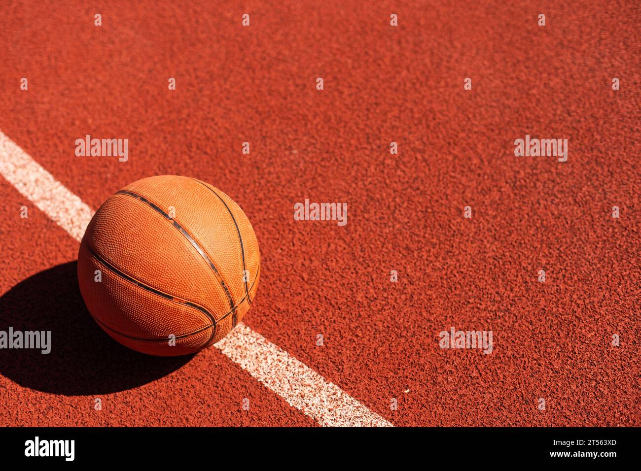 Basketball on Court Floor close up with blurred arena in background ...