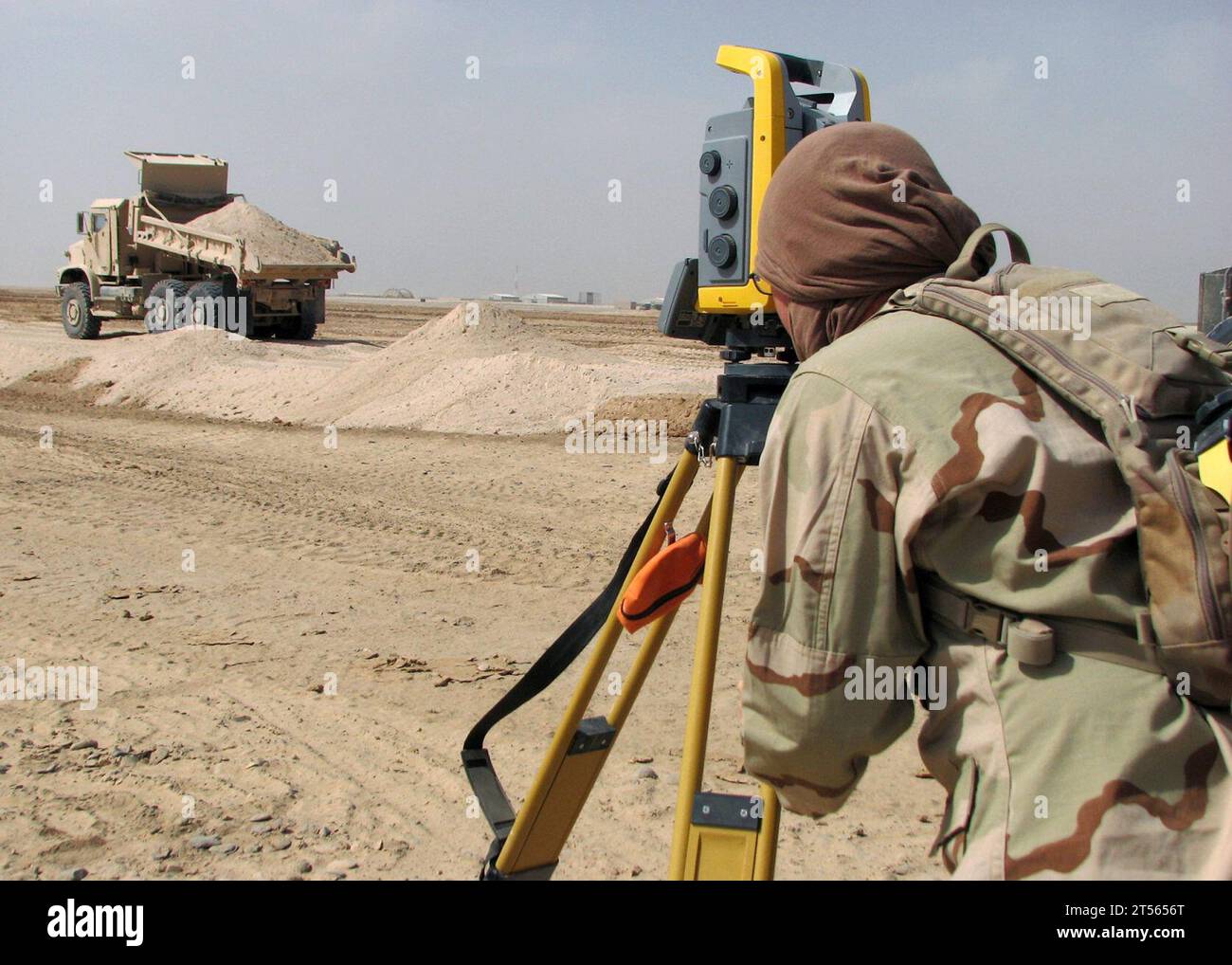 Naval Mobile Construction Battalion (NMCB) 5, Seabee, surveys the ...