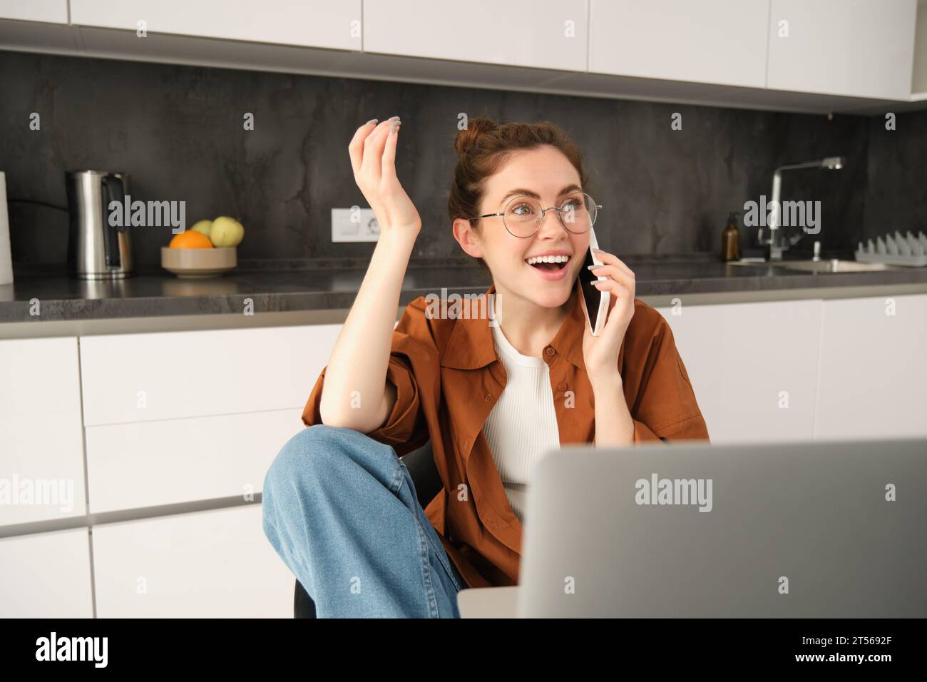 Portrait of young professional, business owner at home, talking on ...