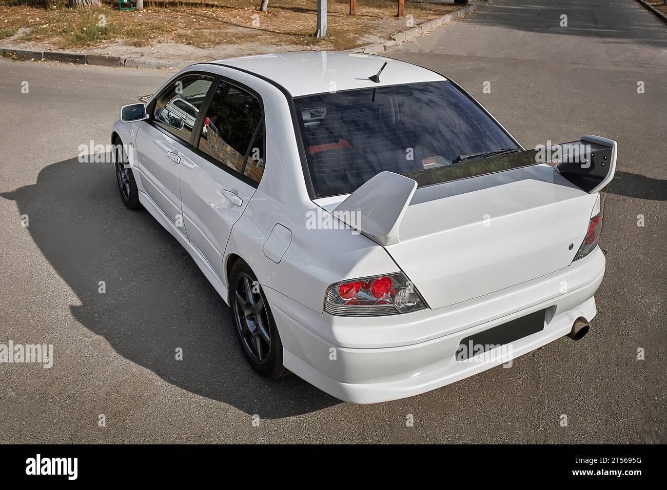 White car on a street background. Modern city sport car with a spoiler ...