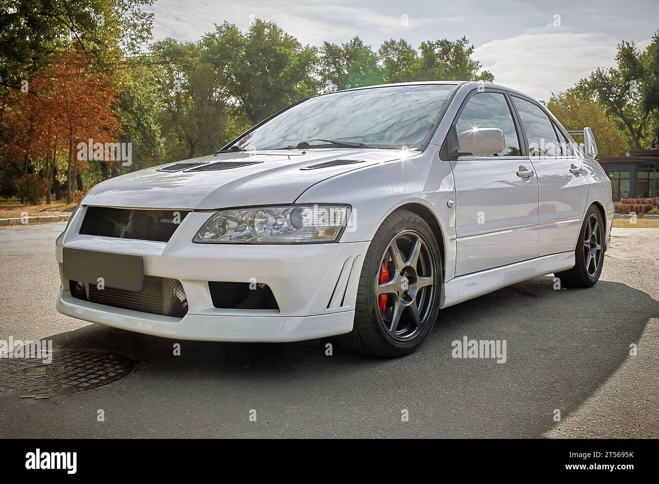 White car on a street background. Modern city sport car with spoiler ...