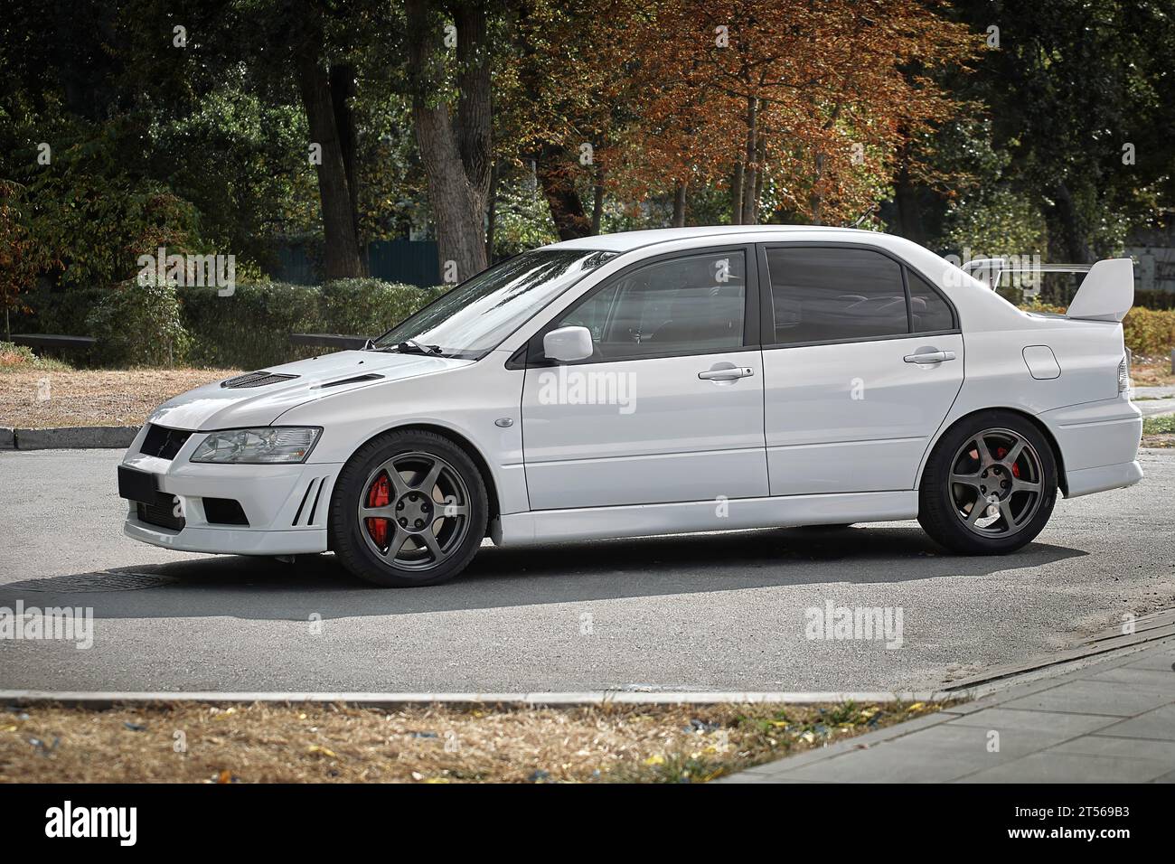 White car on a street background. Modern city sport car with a spoiler ...