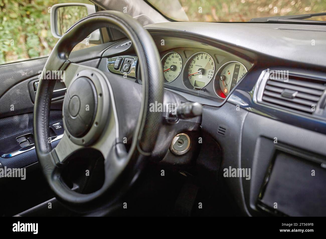 Car steering wheel and car sensors, inerior background, modern city car ...