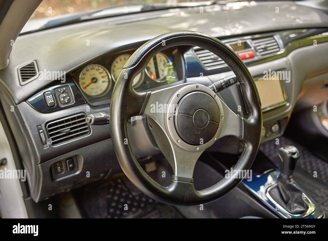 Car steering wheel and car sensors, inerior background, modern city car ...