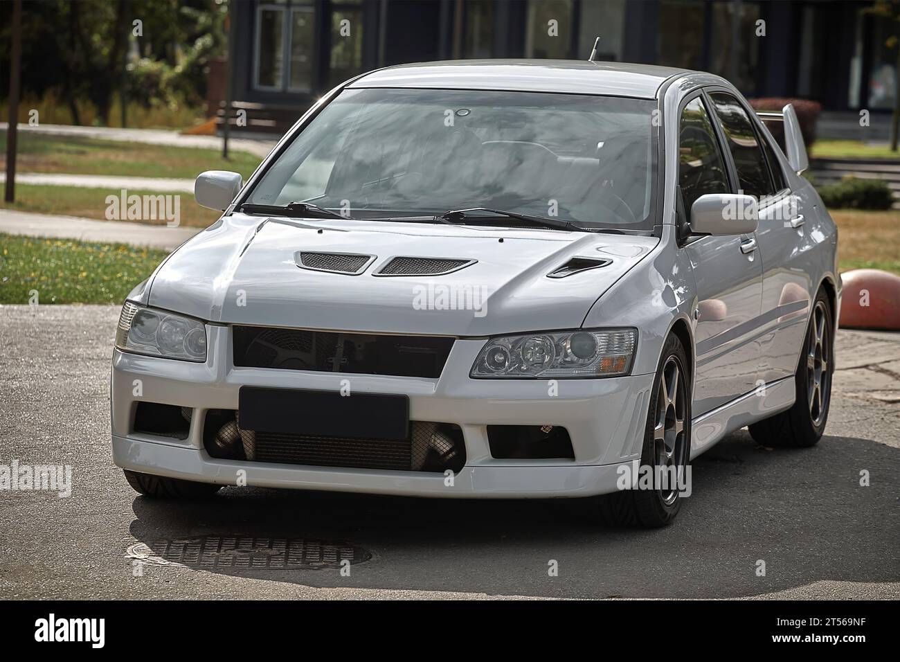 White car on a street background. Modern city sport car with a spoiler ...