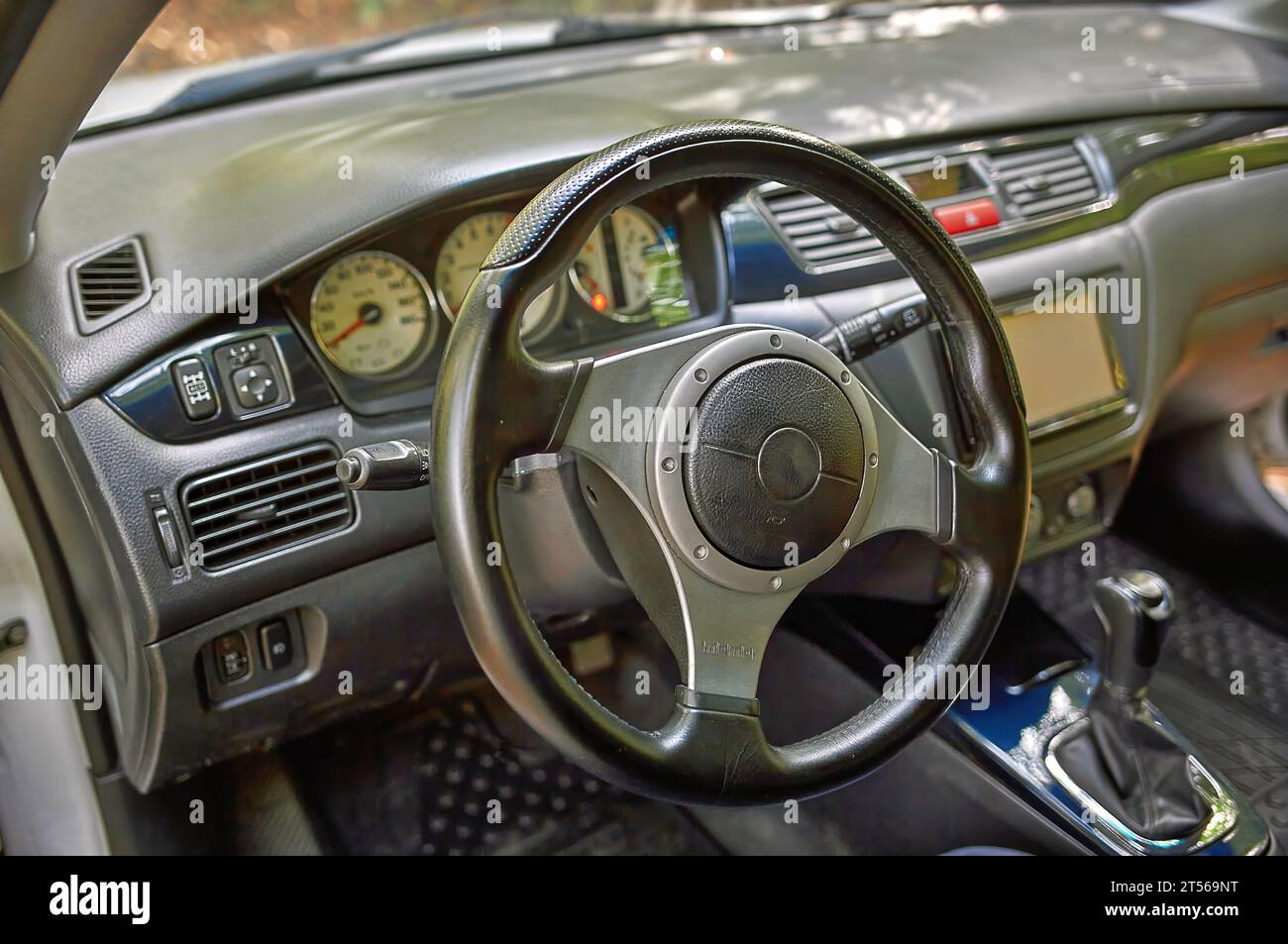 Car steering wheel and car sensors, inerior background, modern city car ...