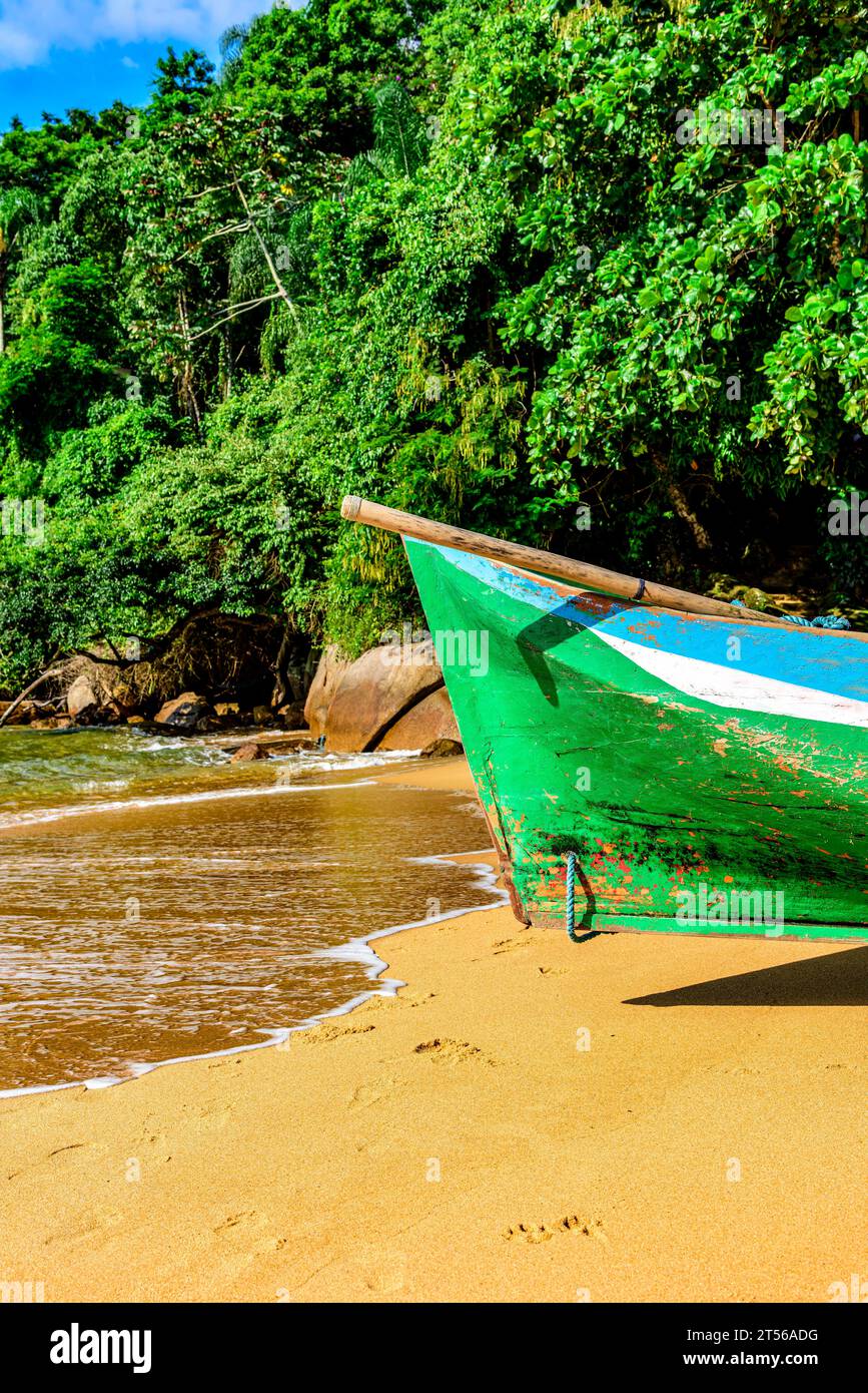 Rustic rowing canoe used for fishing on a paradisiacal beach and desert ...