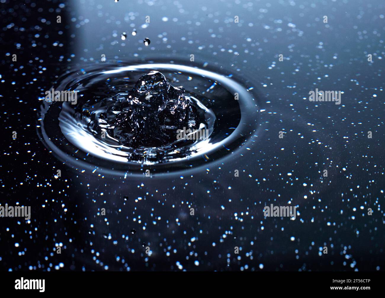 Splash - a drop of water falling and breaking on the water surface ...