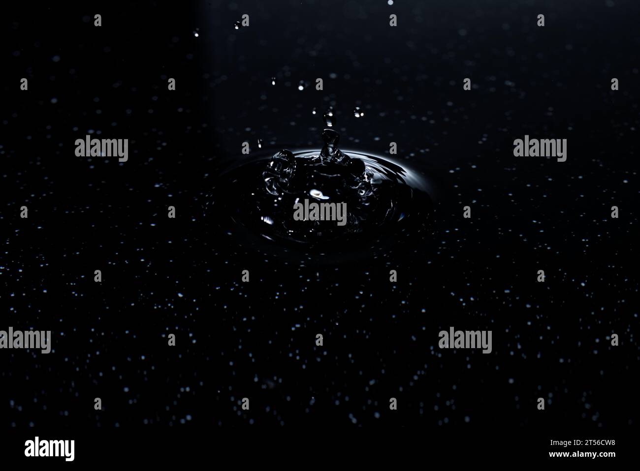 Splash - a drop of water falling and breaking on the water surface ...