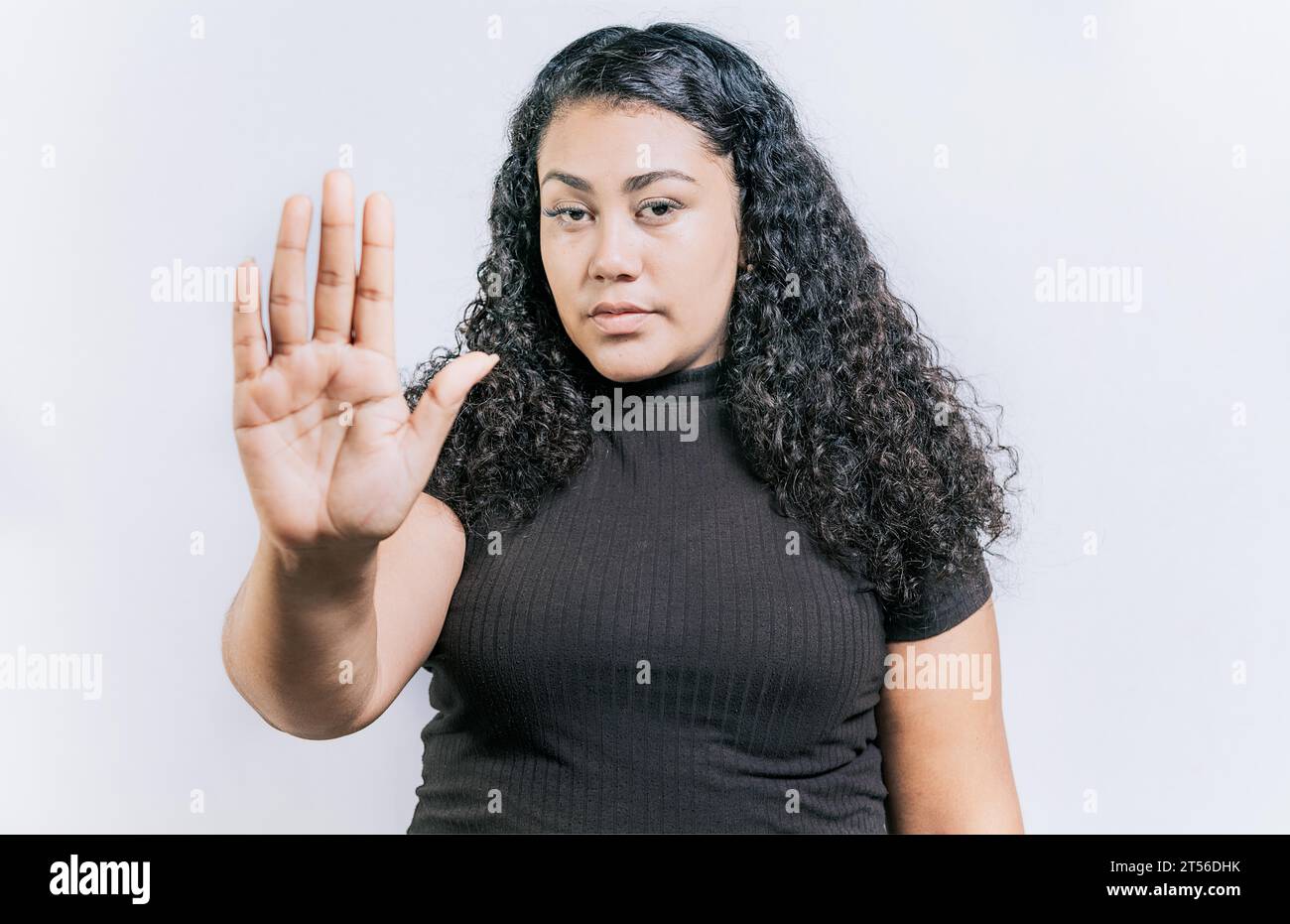 Close up of woman gesturing stop with the palm of hand isolated. People ...