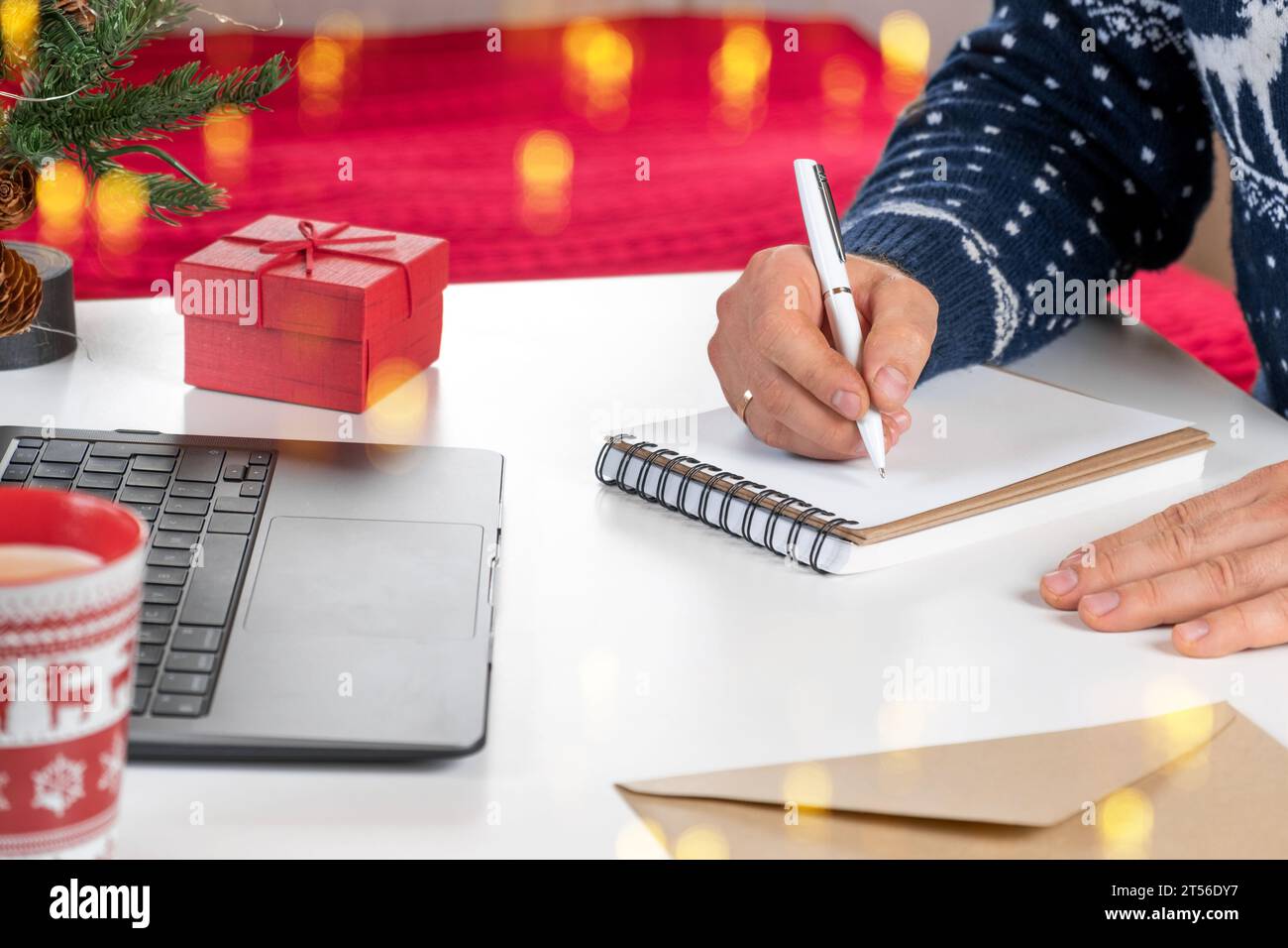 Writing a Christmas Wishing Card. Male adult making greeting cards at ...