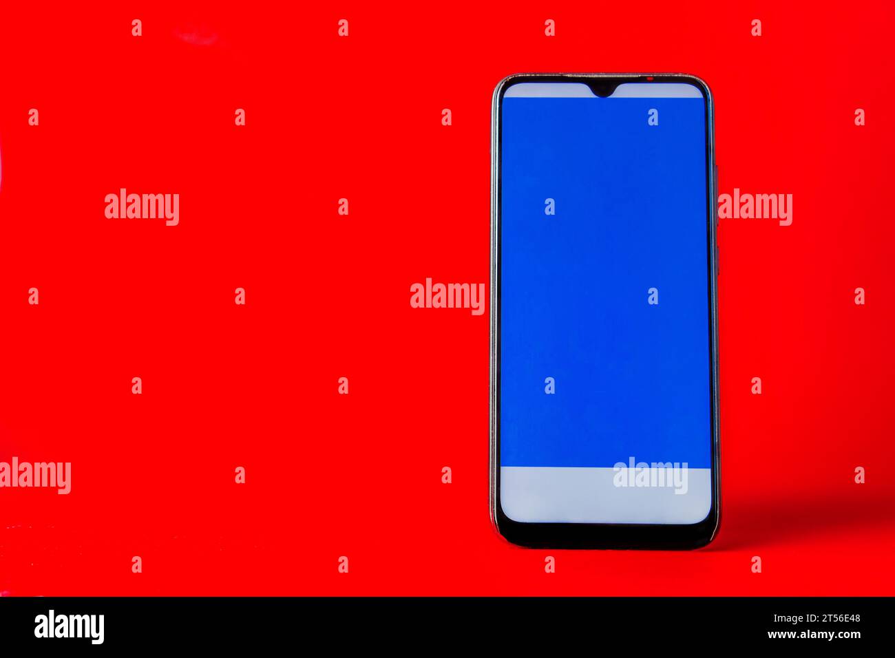 Mobile phone with blue screen isolated on a red background Stock Photo ...