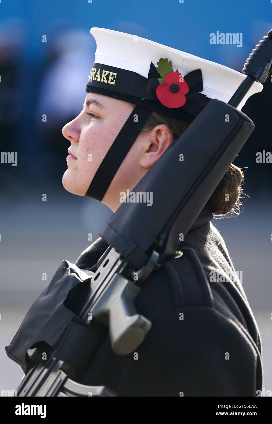 A poppy is seen in the cap of a Royal Navy rating as members of the ...