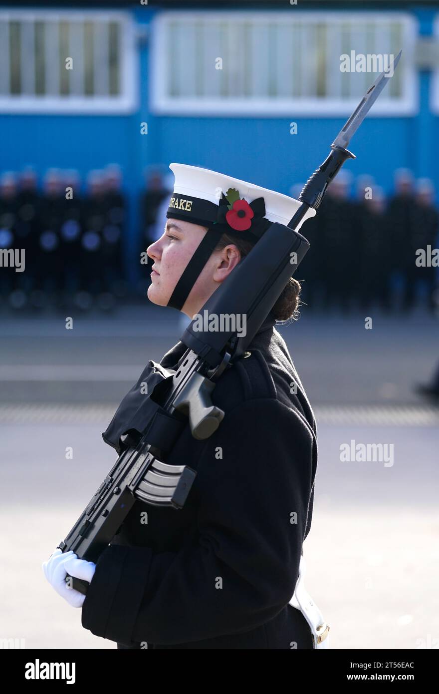 A poppy is seen in the cap of a Royal Navy rating as members of the ...