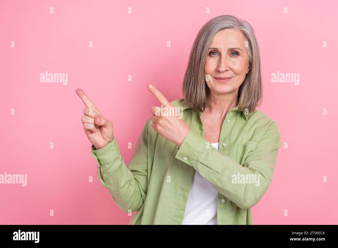 Photo of attractive retired woman wear trendy khaki shirt pointing ...