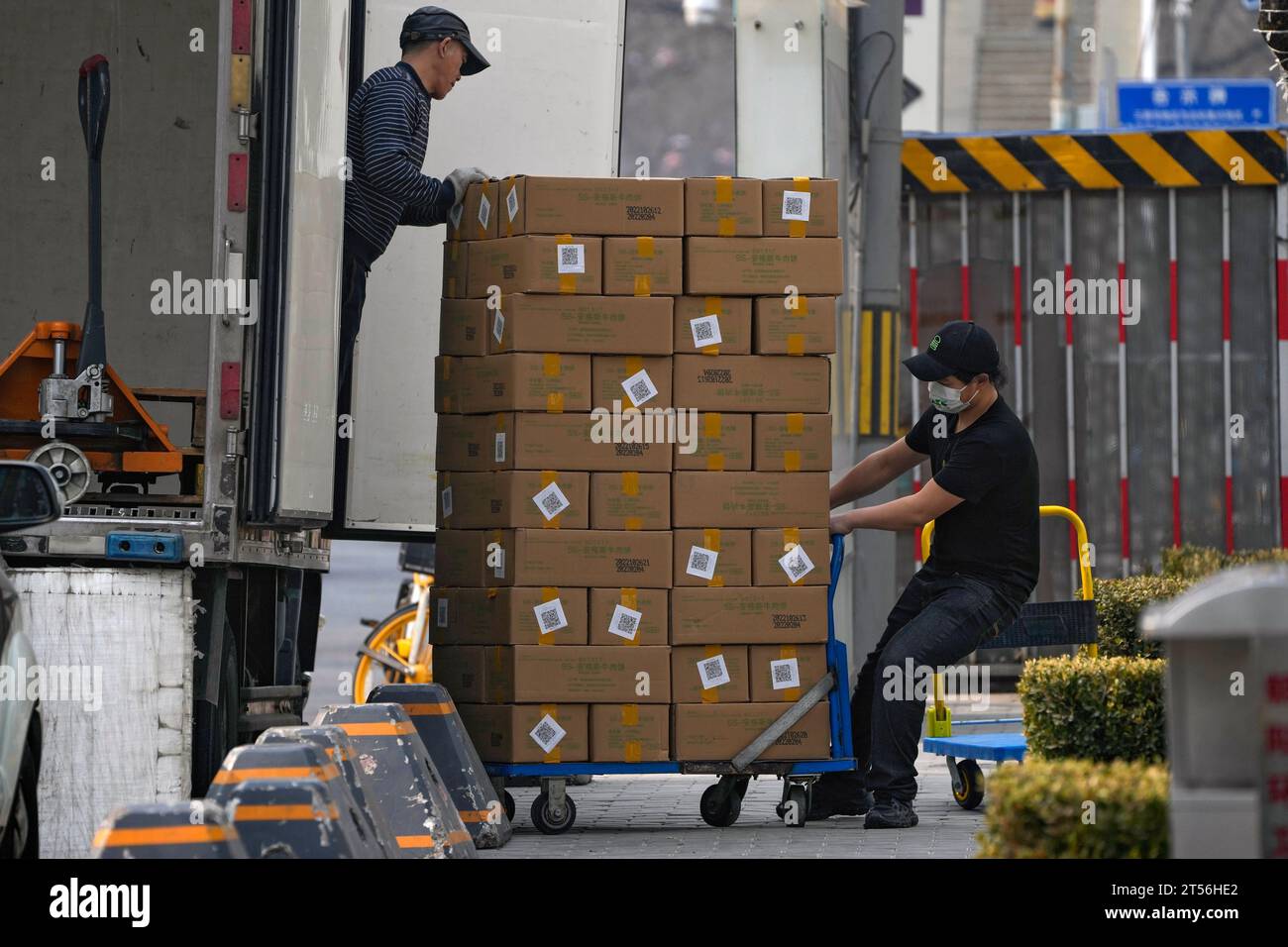 FILE - Workers offload boxes containing frozen beef from a truck for a ...
