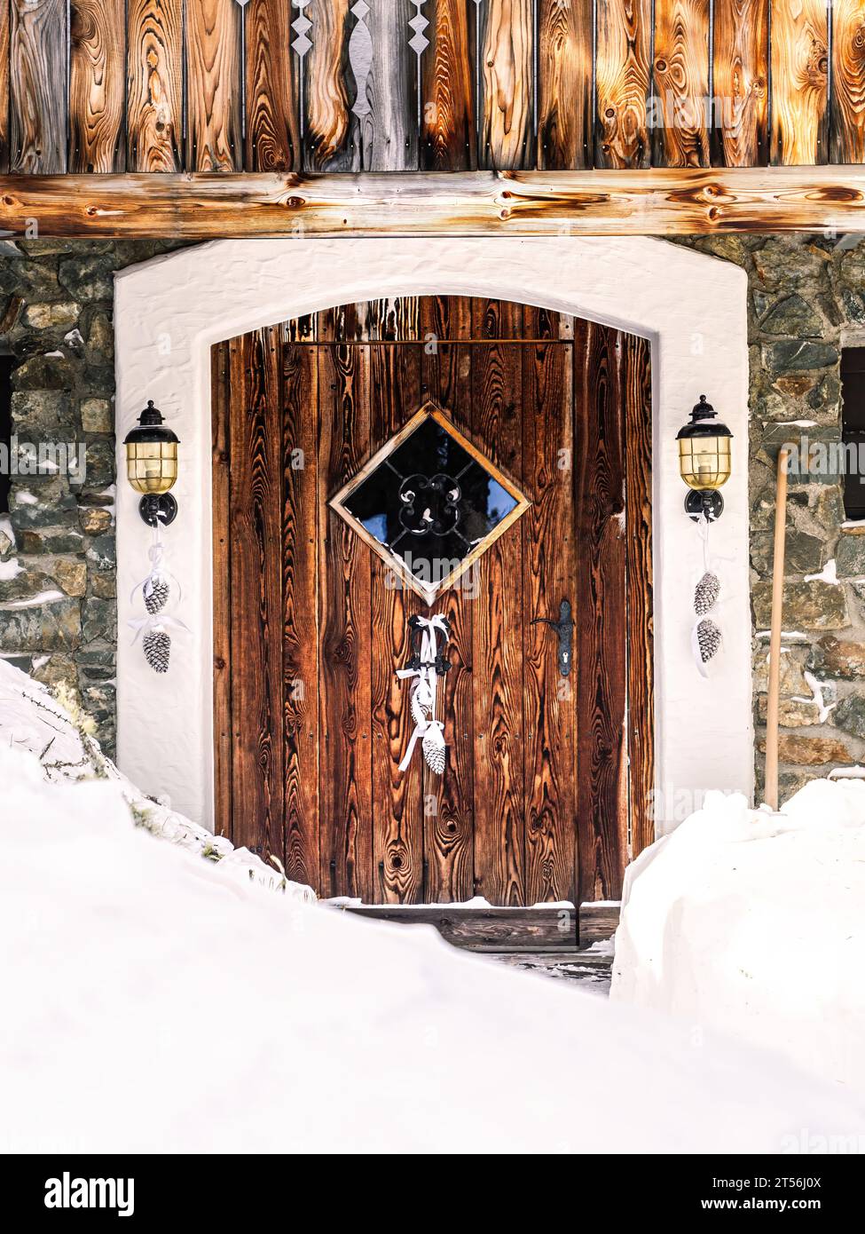 Vintage rustic wooden door of a stone house with winter ornaments and ...