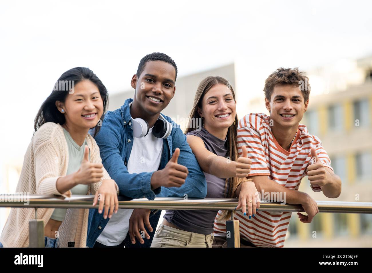 Beautiful group of friends satisfied and looking at camera leaning on a ...