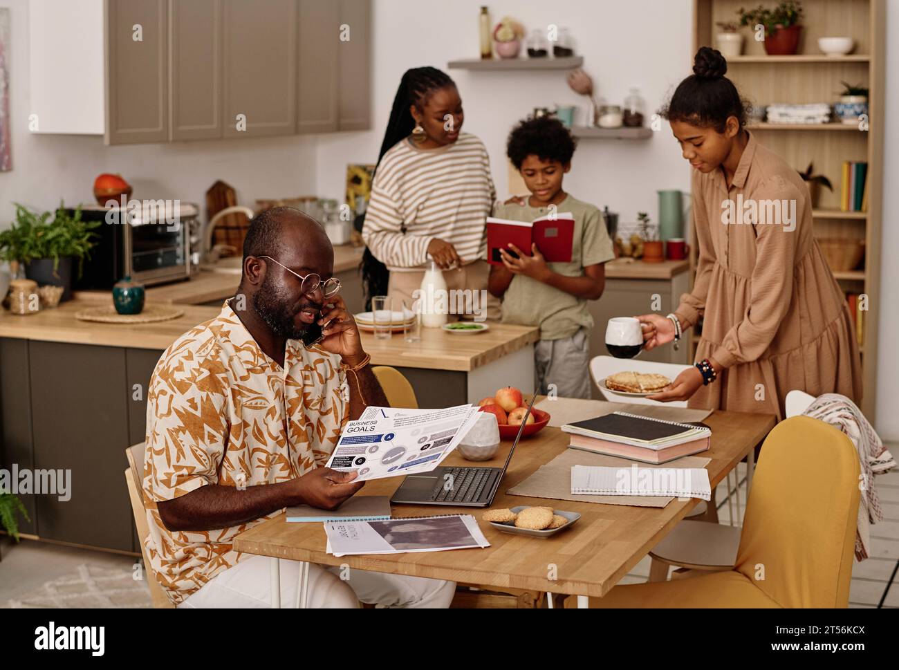Black family spending time at home, working and doing homework Stock ...