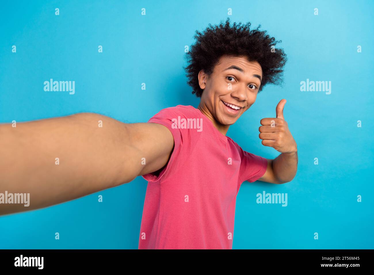Portrait of satisfied funky guy with afro hairdo dressed stylish t ...
