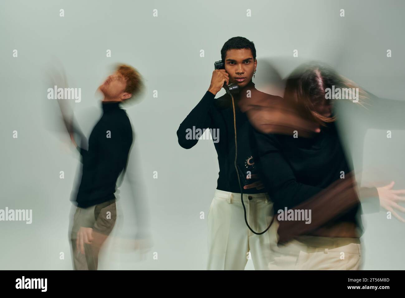 young african american man posing with landline phone with other male ...