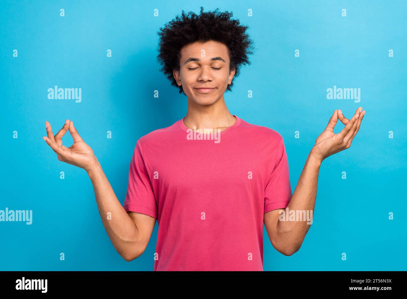 Photo of calm peaceful guy wear pink stylish clothes hands showing om ...
