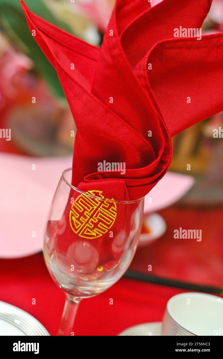 A napkin with Chinese character tucked into a wine glass; an art form ...