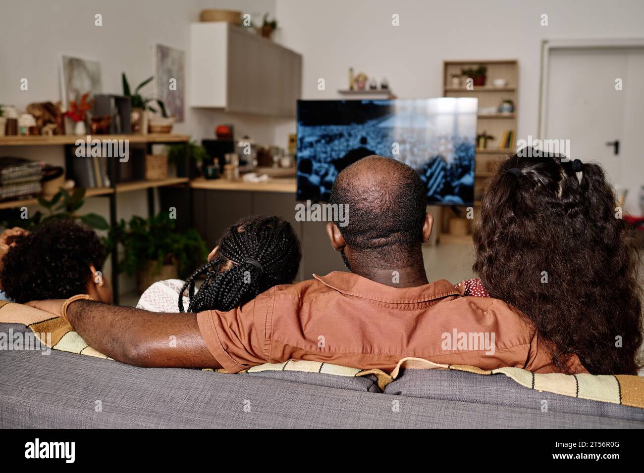 Black family watching recorded speech of Martin Luther King Jr on tv ...