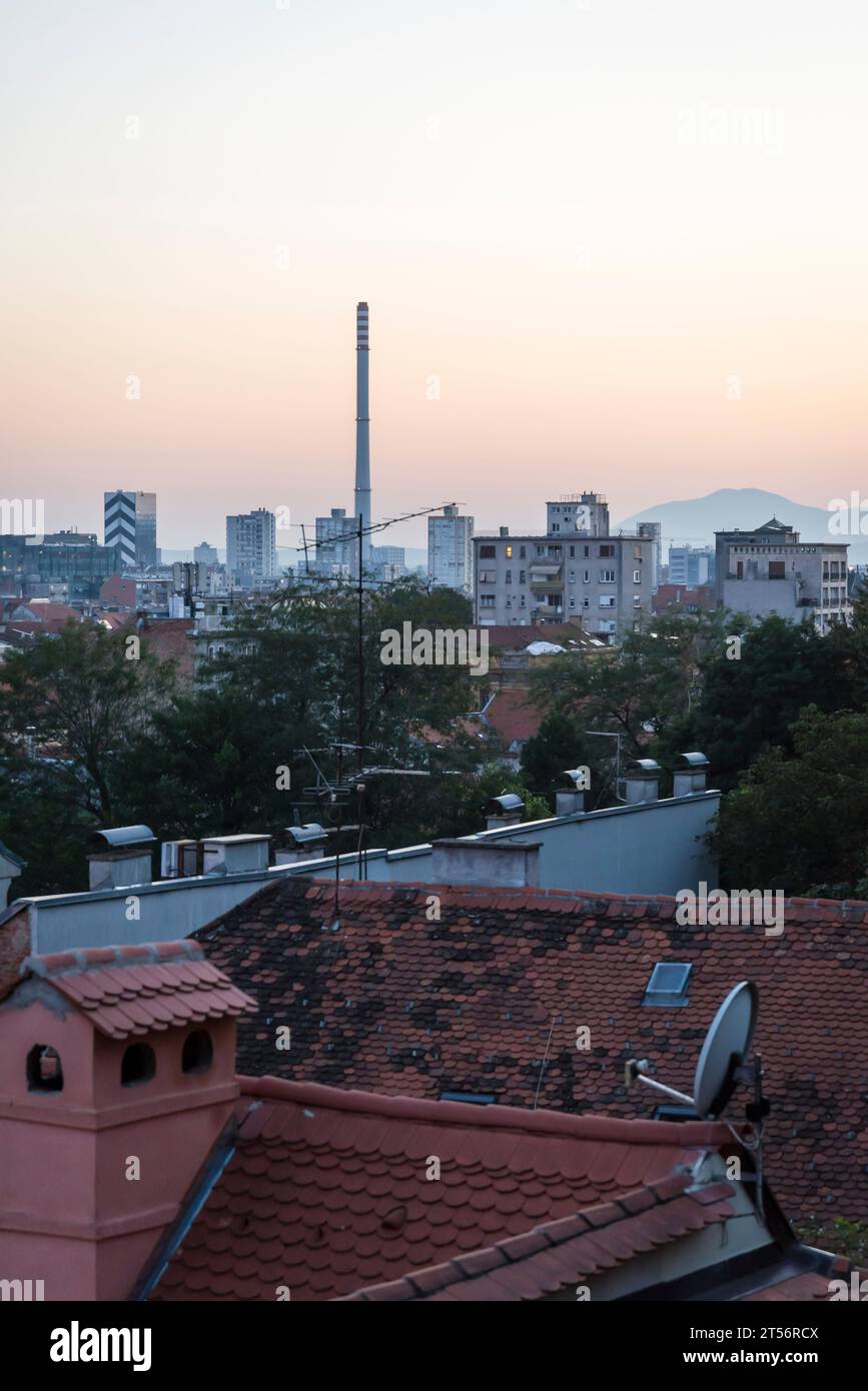 Cityscape of the lower city with an industrial chimney at dusk, Zagreb ...