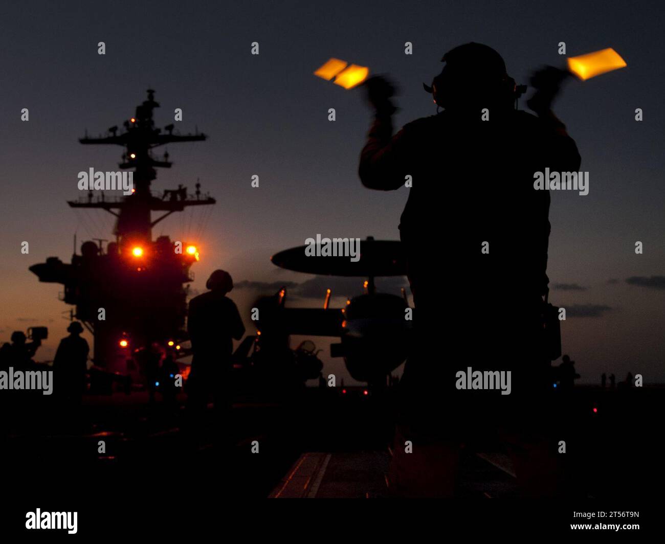 aircraft director guides an E-2C Hawkeye assigned to Carrier Airborne ...