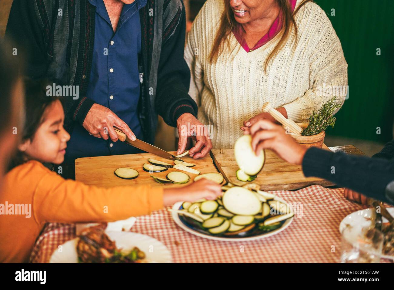 Happy latin family cooking together during dinner time at home - Soft ...