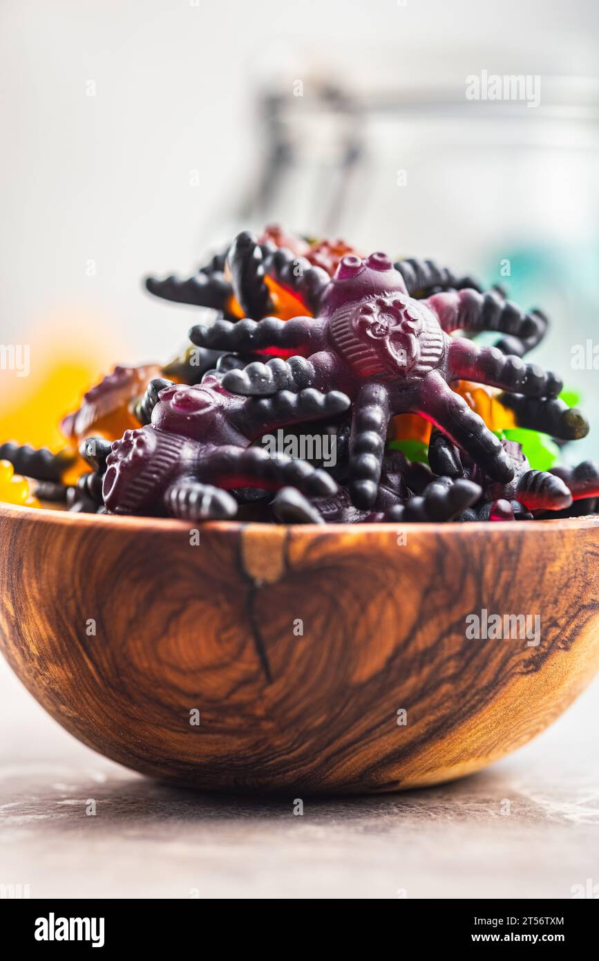 Scary sweet jelly spiders. Halloween candies in the wooden bowl Stock ...