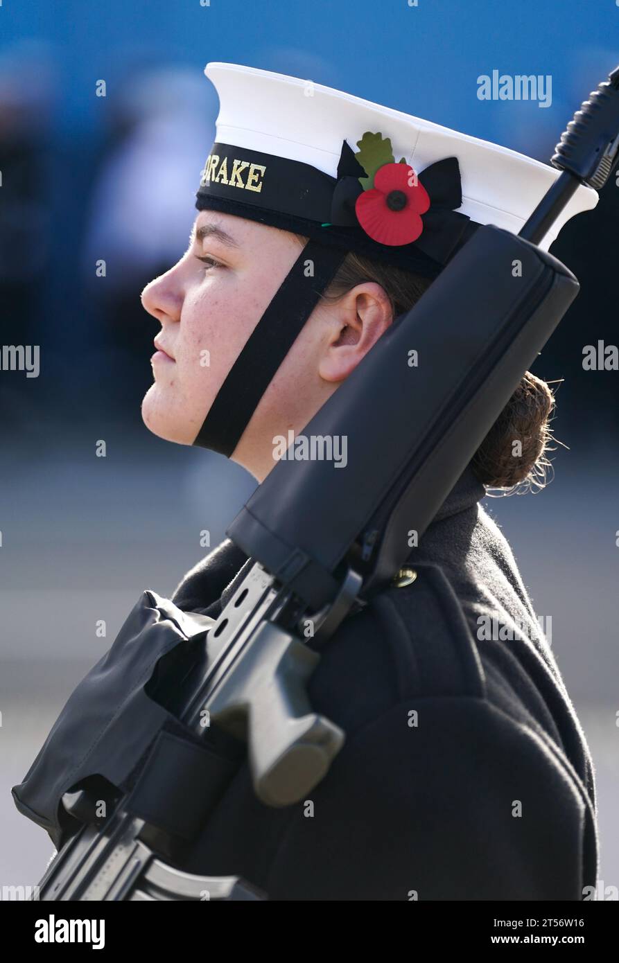 A poppy is seen in the cap of a Royal Navy rating as members of the ...