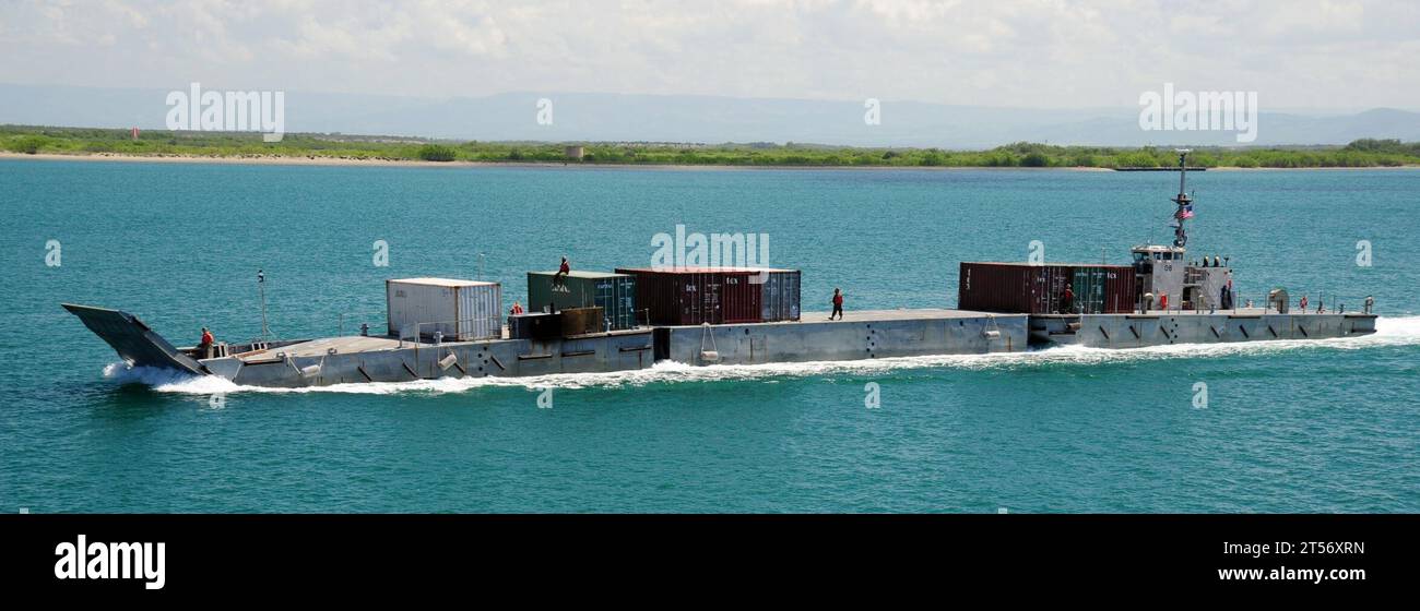 US Navy A floating causeway transports cargo containers from the ...