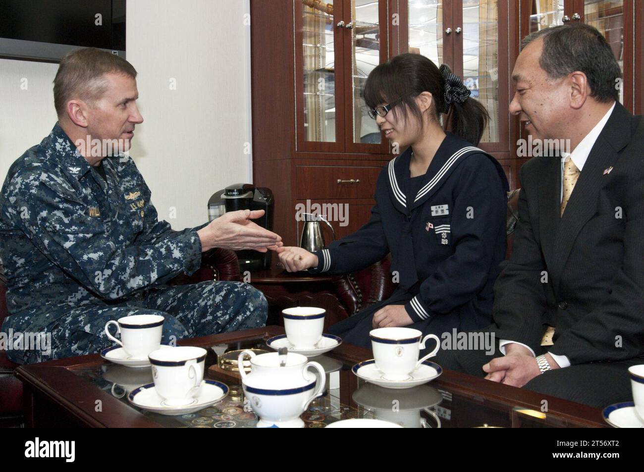 US Navy A CO presents a command coin to a visitor of the ship.jpg Stock ...