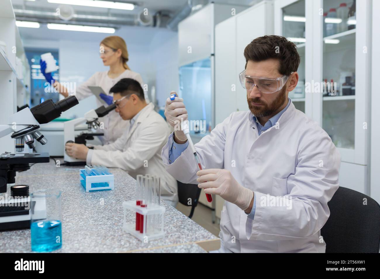 Mature serious and concentrated man works inside the laboratory ...