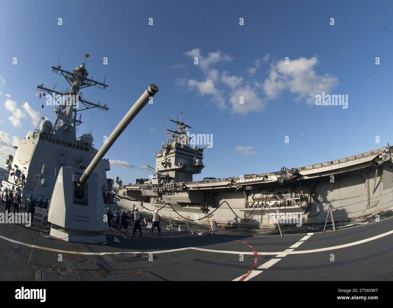 US Navy A fuel line is extended from the aircraft carrier USS ...