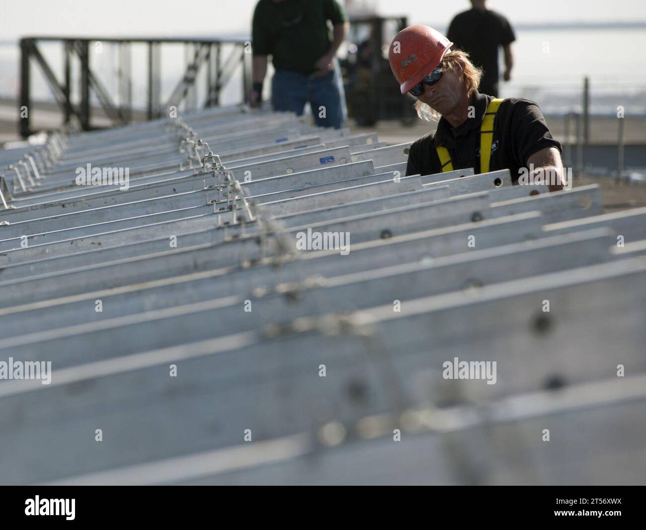 US Navy A civilian contractor installs bleachers on the flight deck as ...