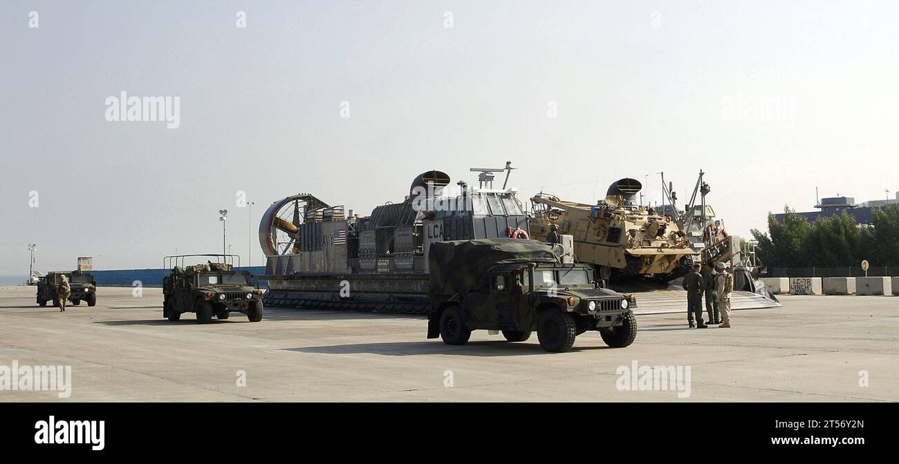 US Navy A landing craft air cushion (LCAC) hovercraft offloads vehicles ...