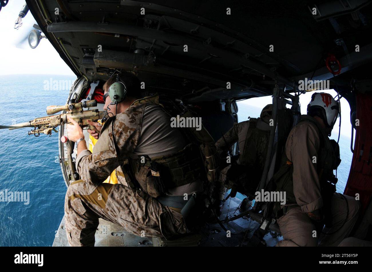 US Navy A Navy SEAL fires an MK-11 sniper rifle from an MH-60S Sea Hawk ...