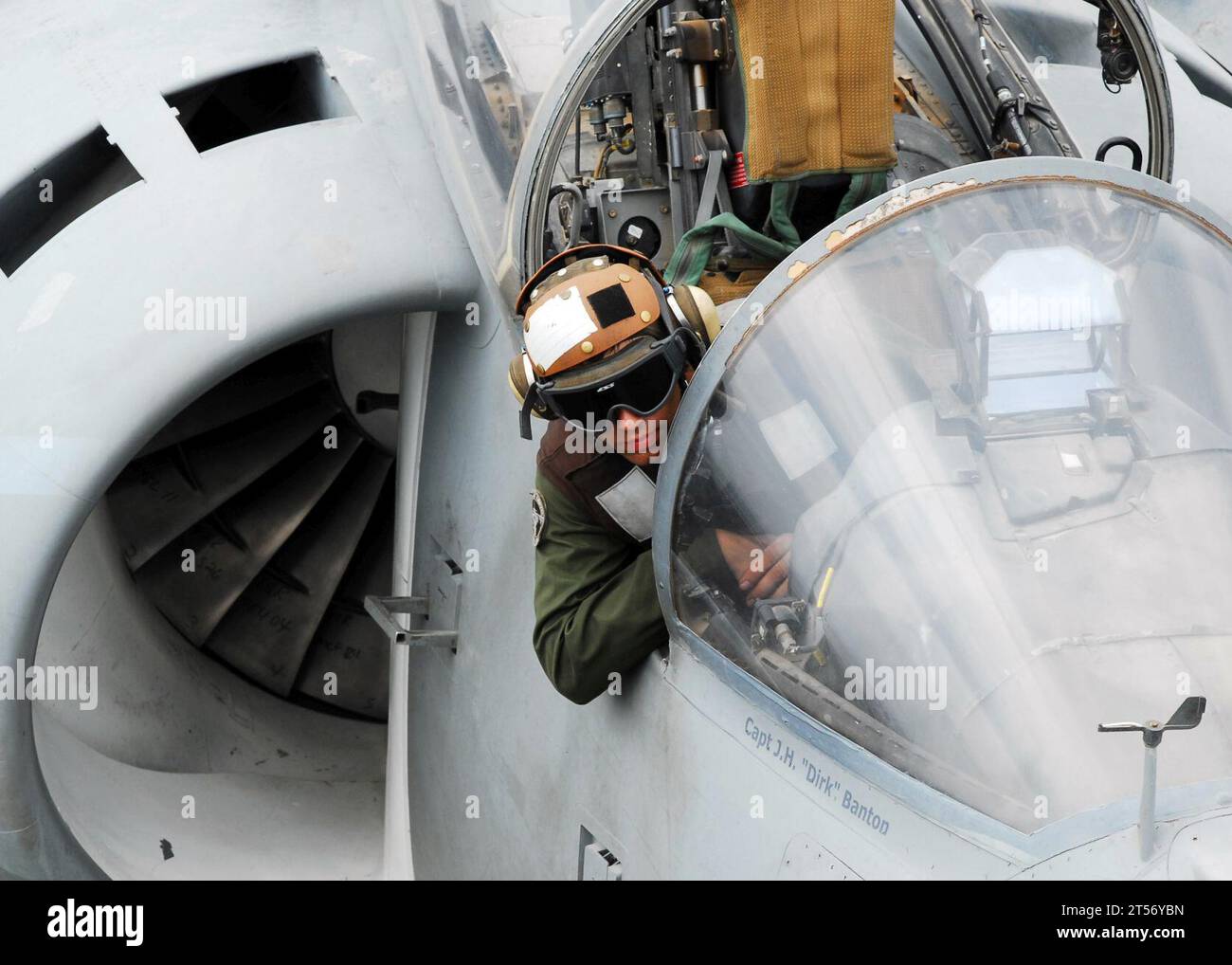 US Navy A plane captain of an AV-8B Harrier jet guides the aircraft as ...