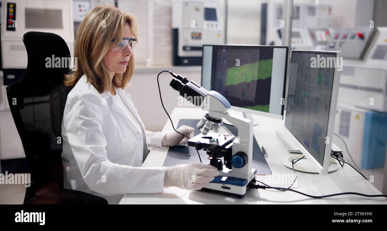 Female Worker in an Electronic Factory Using Computer in Lab Stock ...